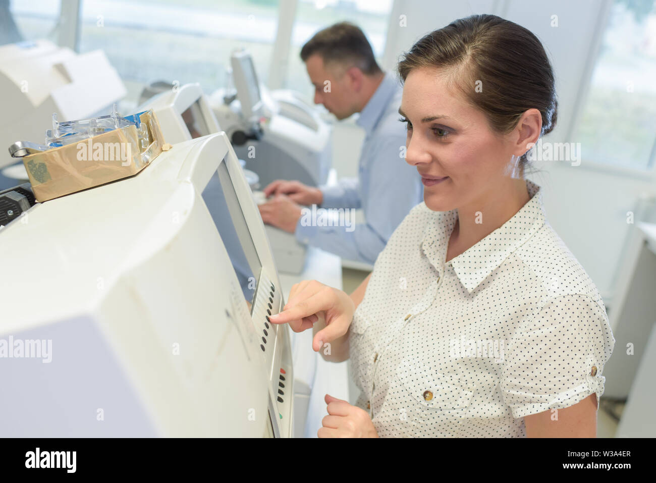 woman working on an industrial machine Stock Photo - Alamy