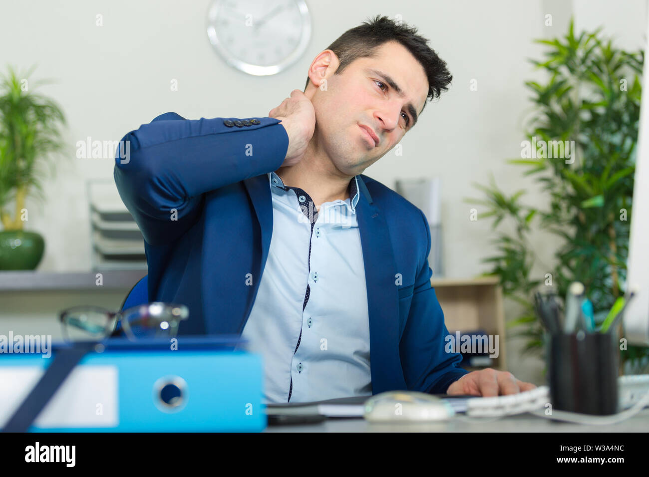 male office worker having stiff neck Stock Photo - Alamy