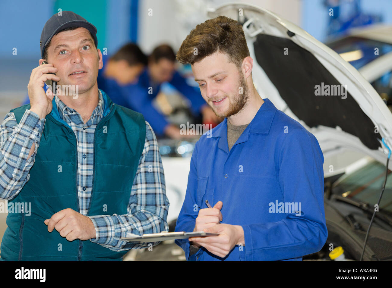 mechanic apprentice holding a clipboard Stock Photo - Alamy