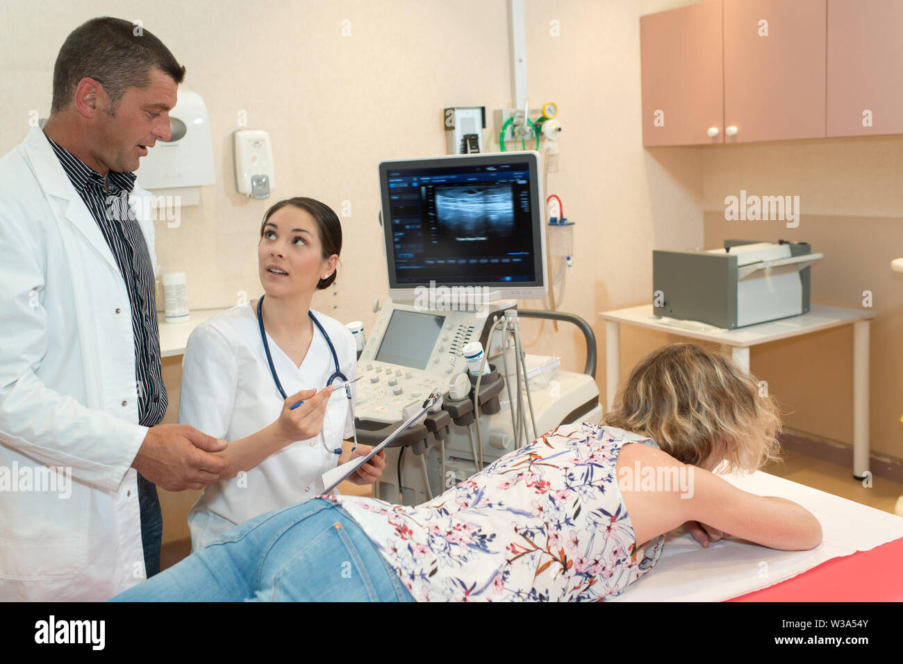 female patient on going back ultrasound Stock Photo - Alamy