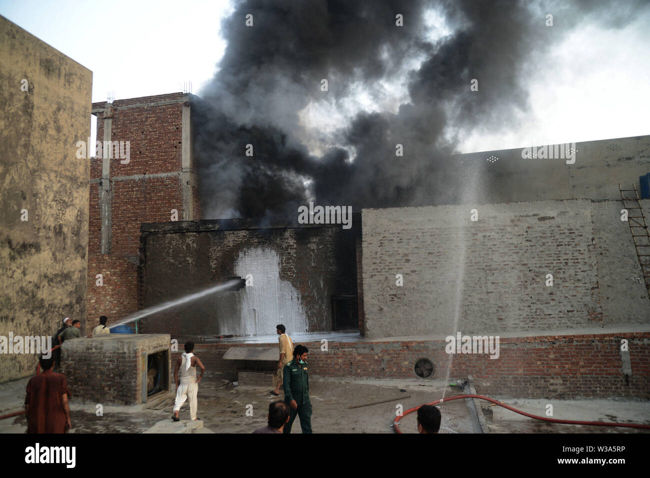 Lahore, Pakistan. 13th July, 2019. A view of erupted smoke as Rescue ...