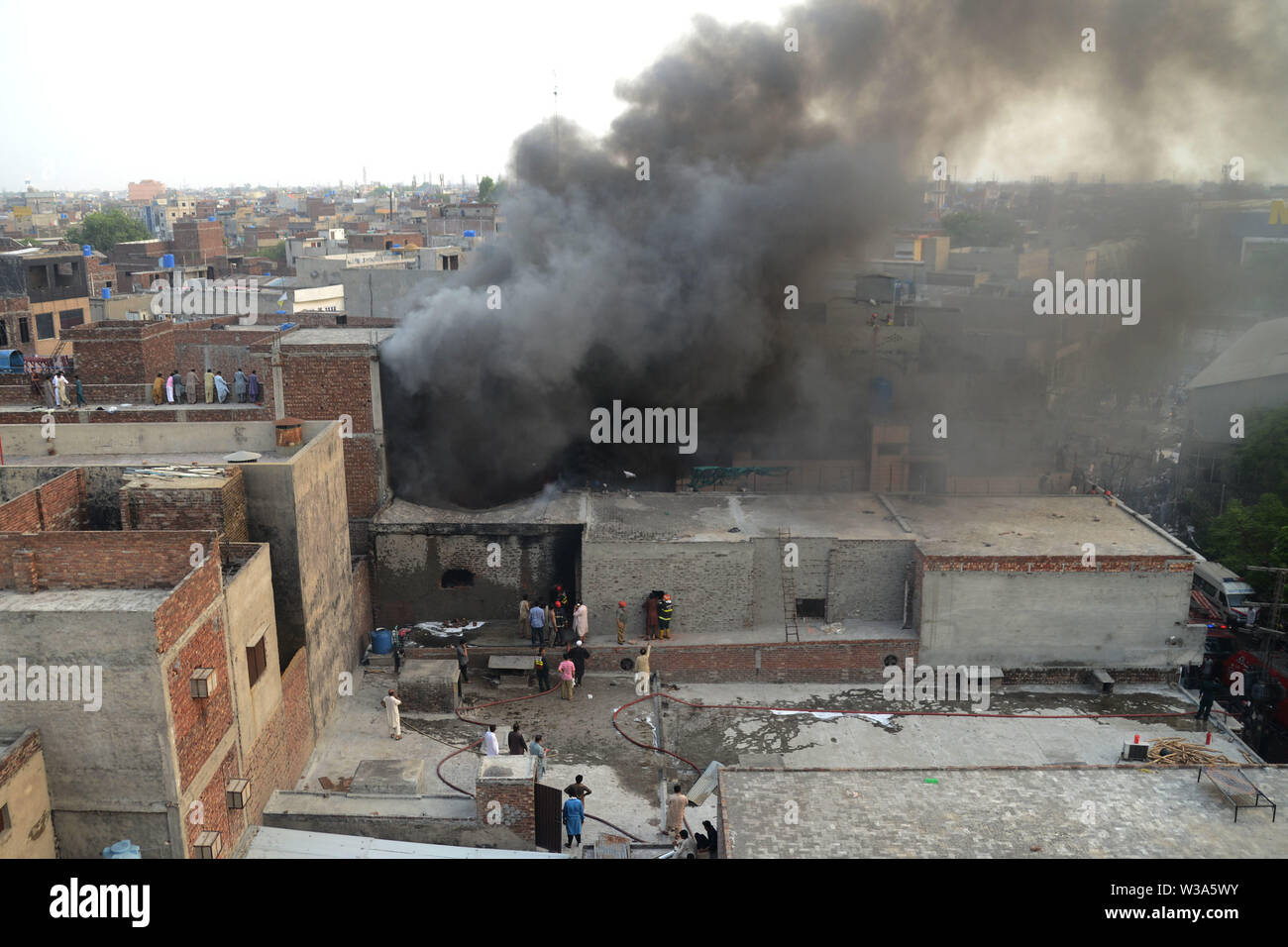 Lahore, Pakistan. 13th July, 2019. A view of erupted smoke as Rescue ...