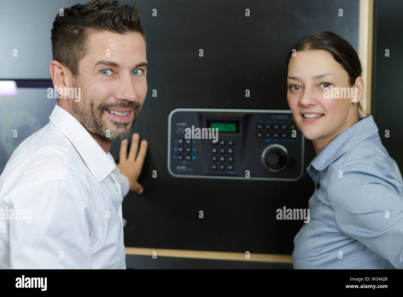 bankers posing next to a vault Stock Photo - Alamy