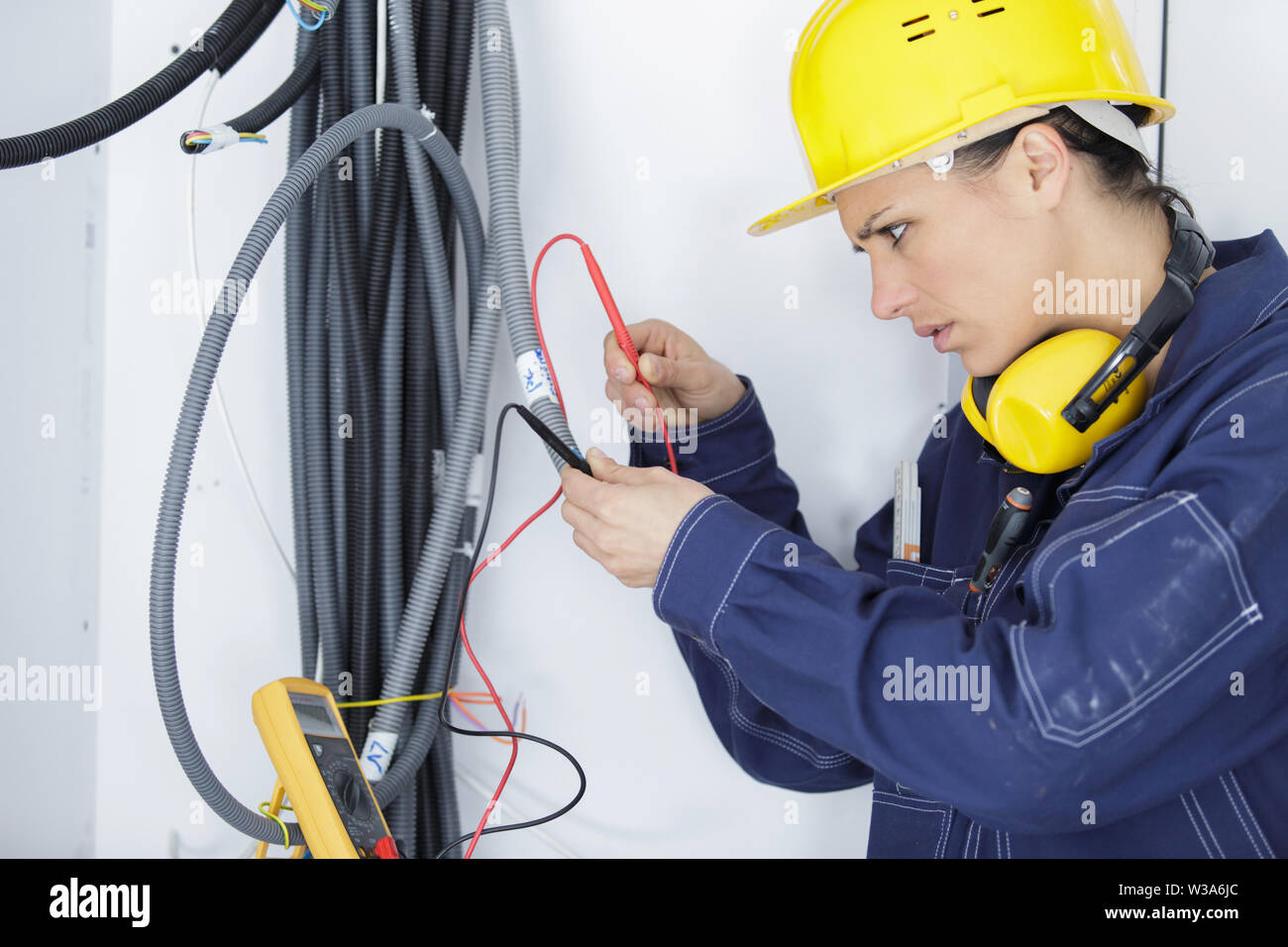 female electrician fitting pipe in building ceiling Stock Photo - Alamy