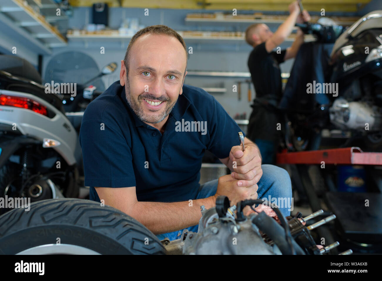happy male mechanic looking at camera Stock Photo - Alamy