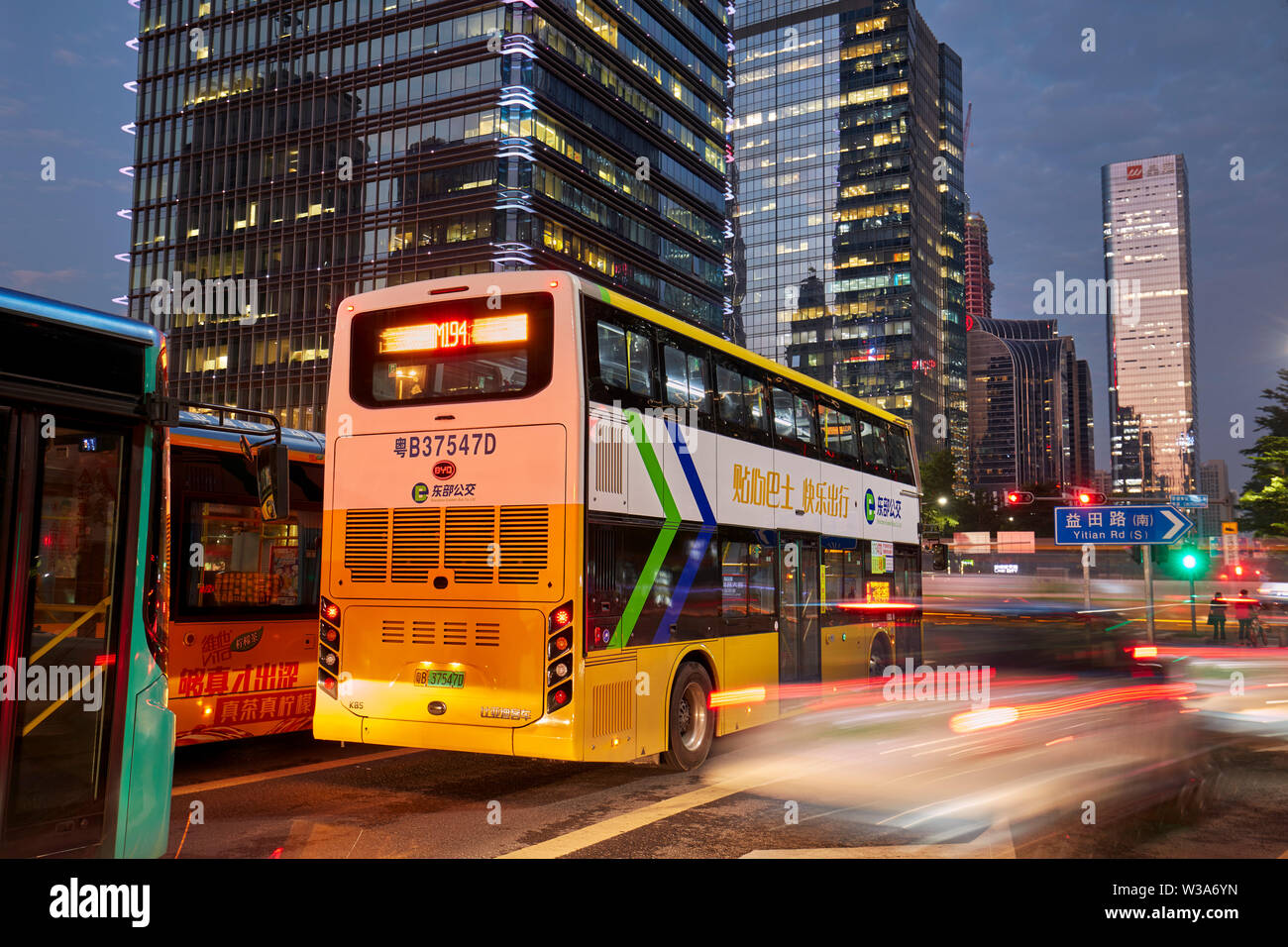 Electric city bus moving on street in Futian Central Business District ...