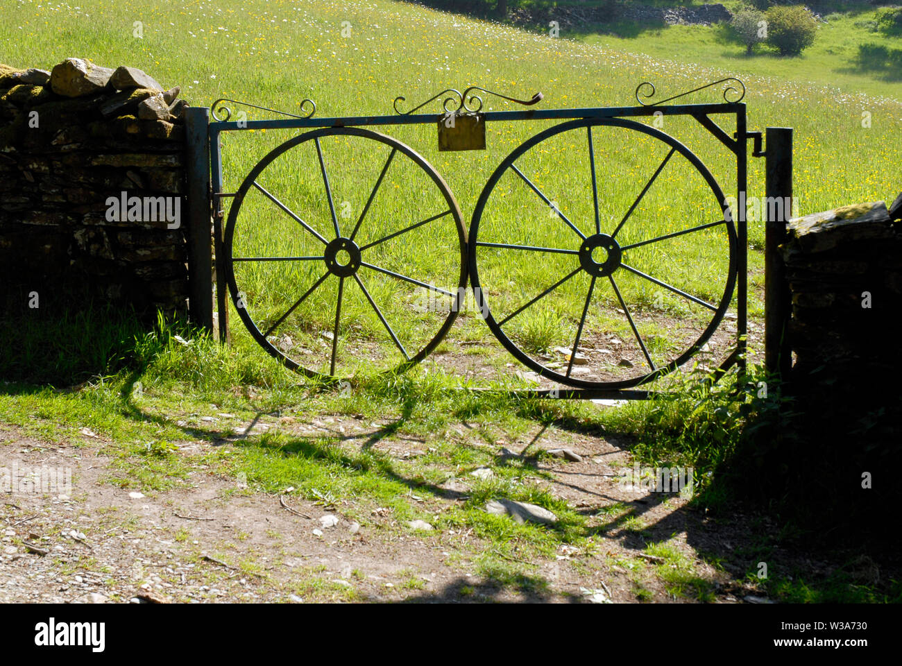 Farm gate made from two old wheel rims and spokes, Cumbria Stock Photo ...