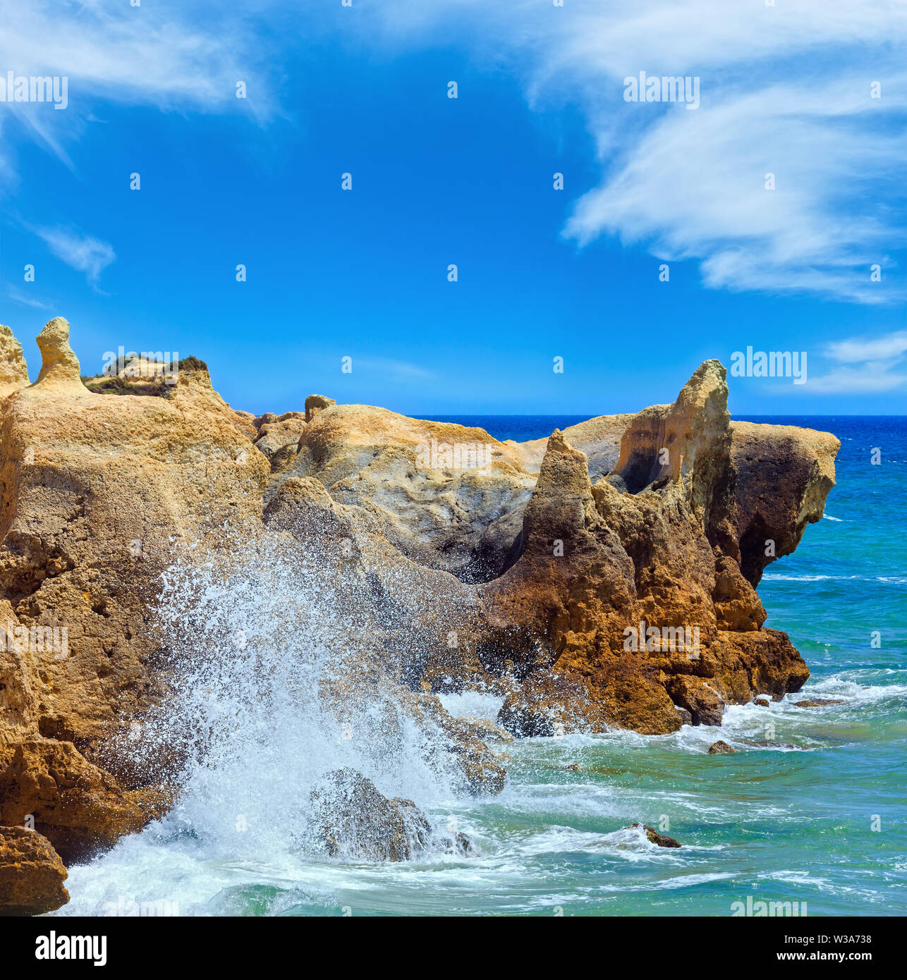 Summer Atlantic rocky coast view with splashes from waves, Albufeira ...