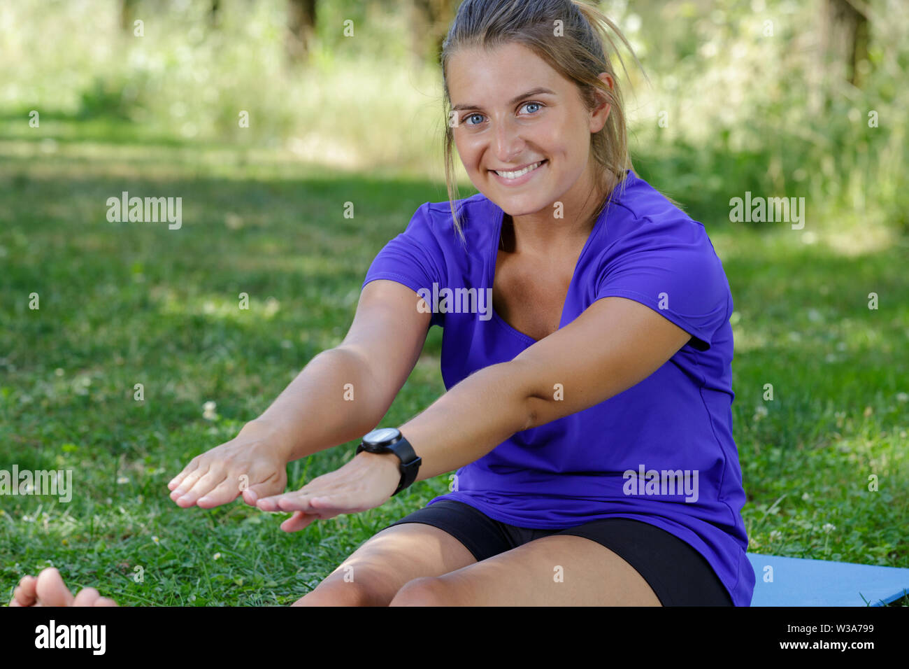 woman doing flexibility routine before exercise Stock Photo - Alamy