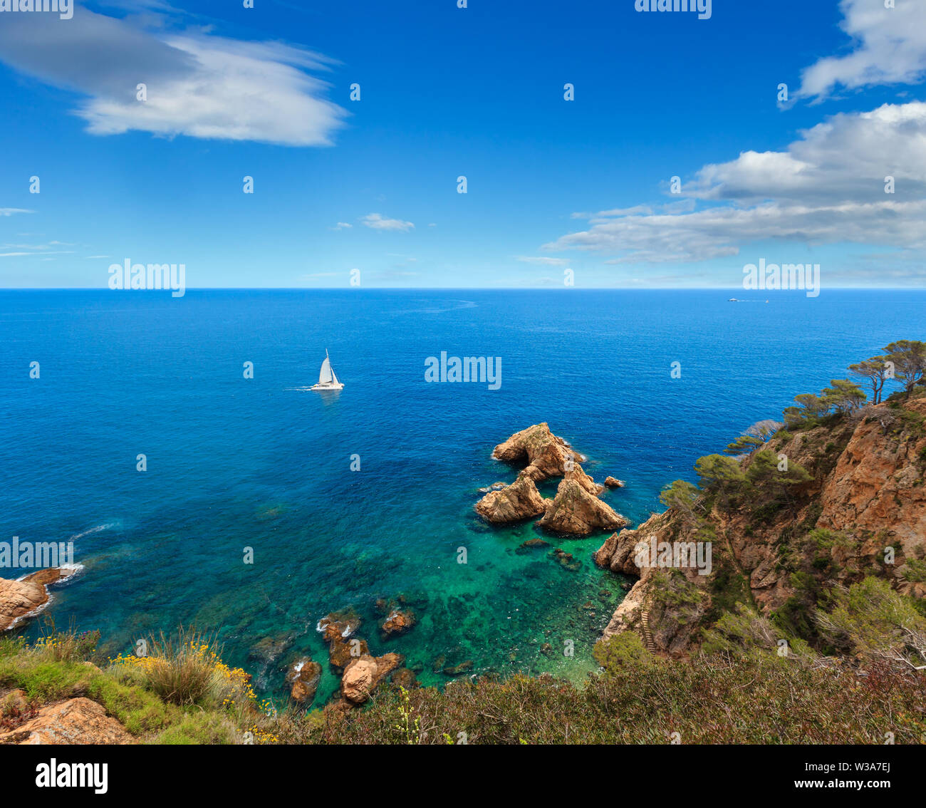Summer sea rocky coast landscape with catamaran, Costa Brava, Spain ...
