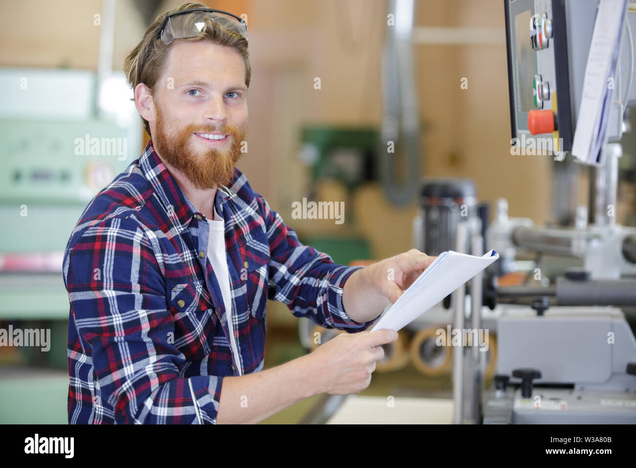 happy man operating cnc machine Stock Photo - Alamy