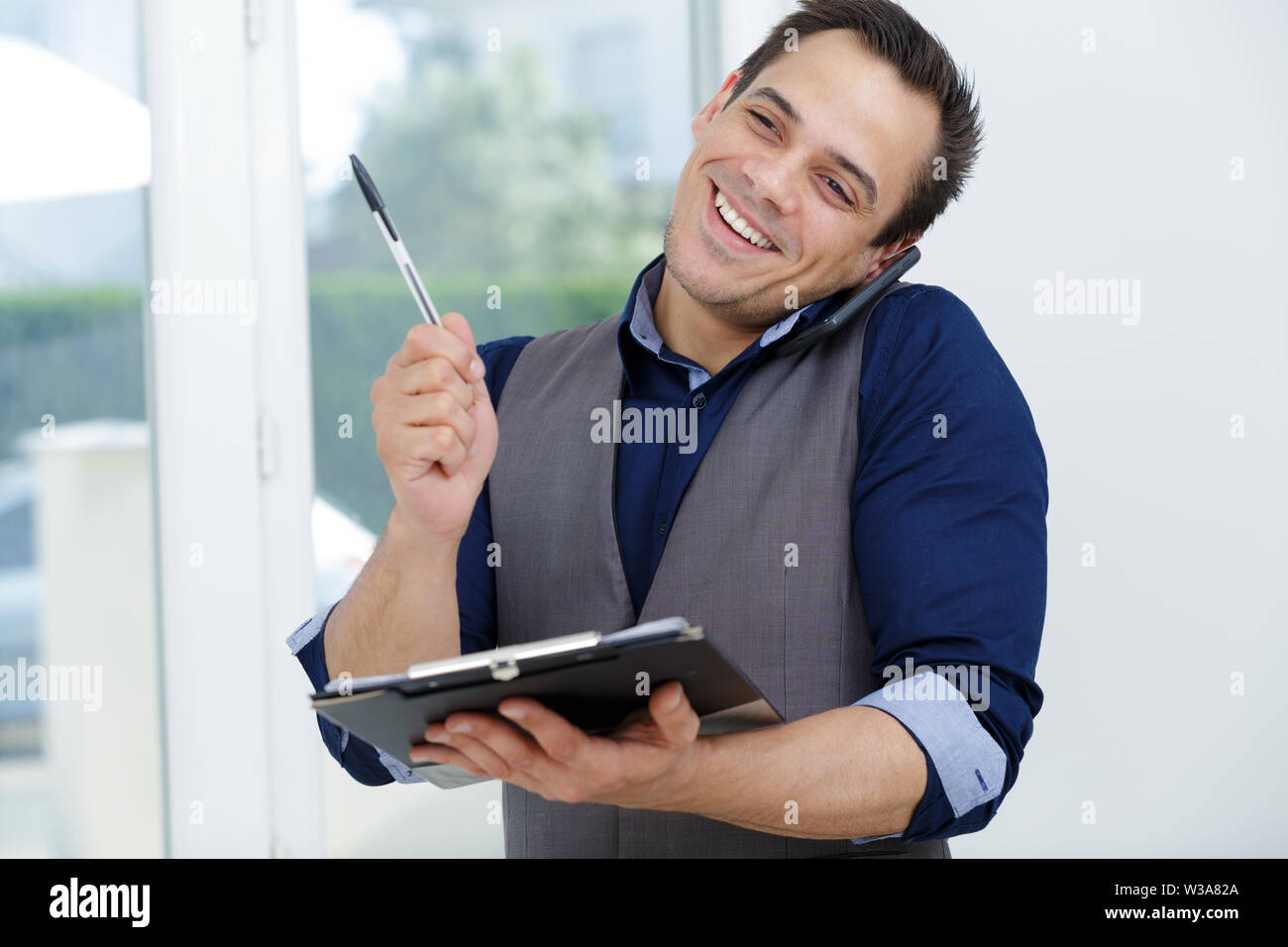 happy customer service representative with clipboard looking away in ...