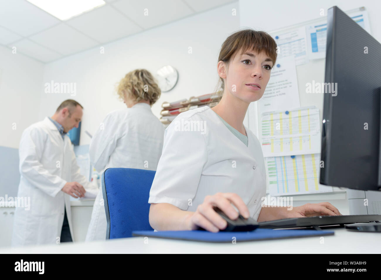 nurse typing on computer keyboard Stock Photo - Alamy