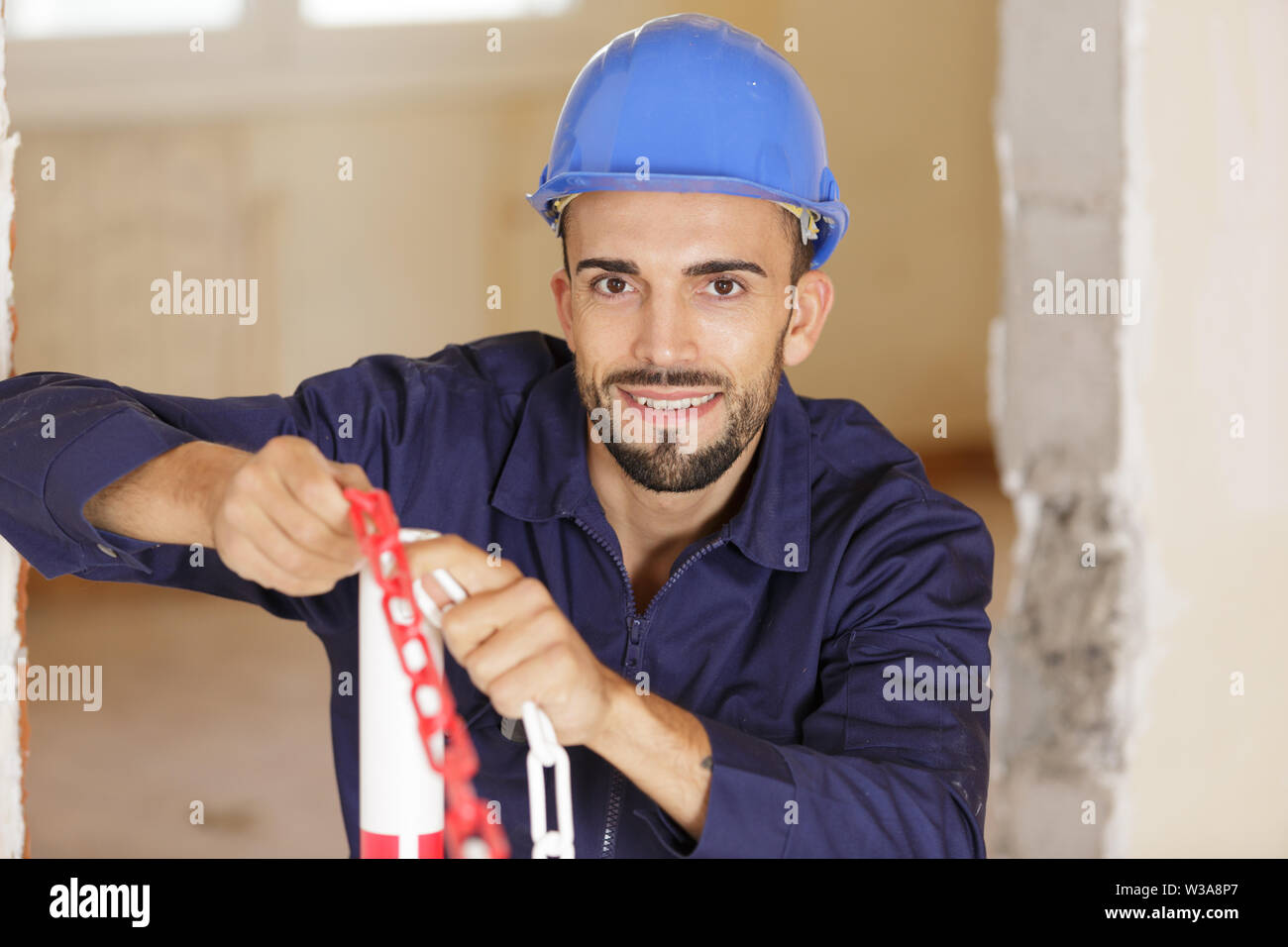 builder putting a chain around the work site Stock Photo - Alamy