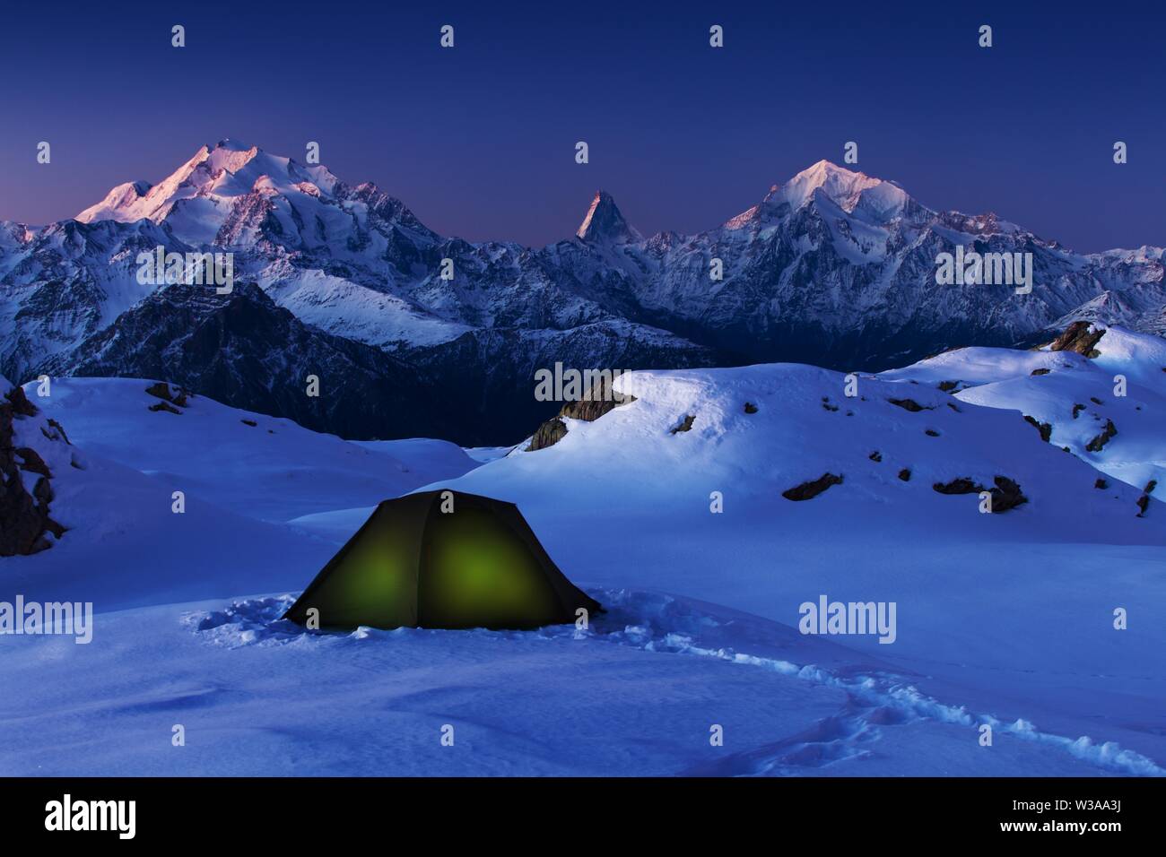 Winter camp, night, shining green tent in the snow. Night shot, long ...