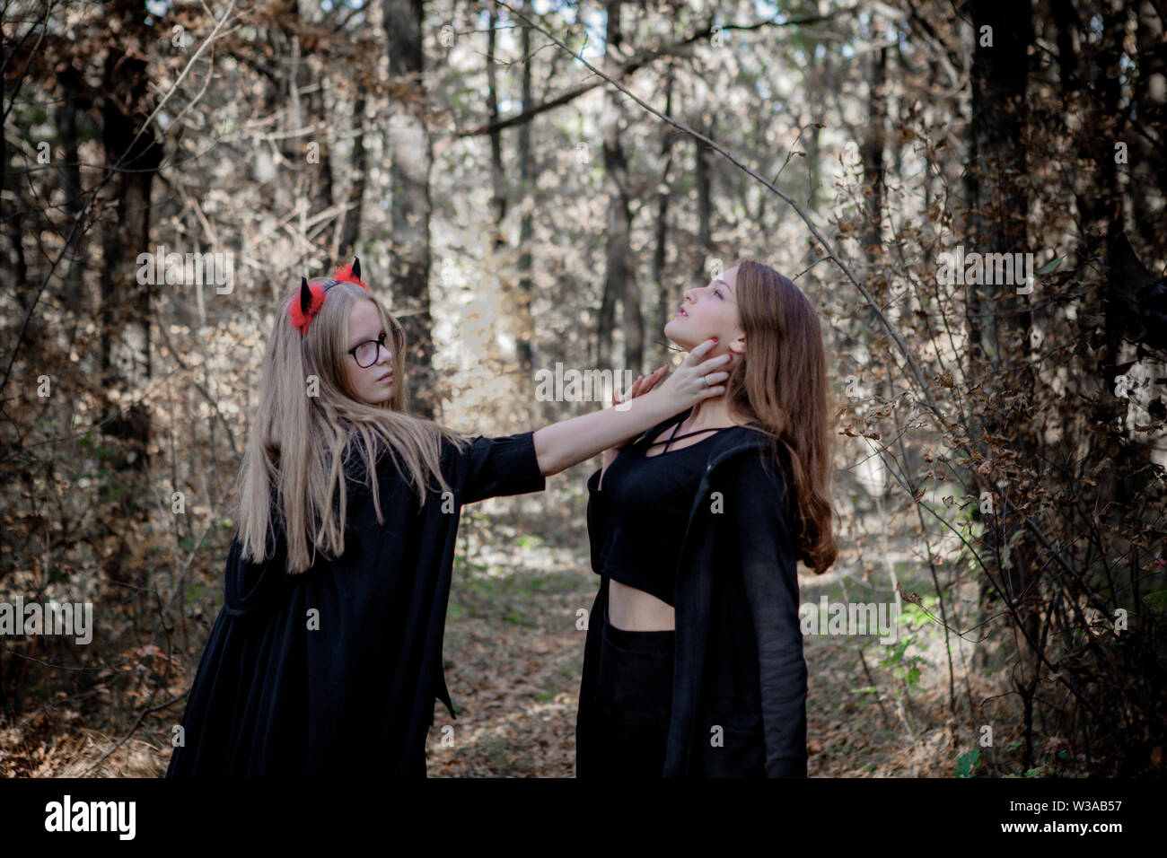 Halloween demon and witch in the woods Stock Photo - Alamy