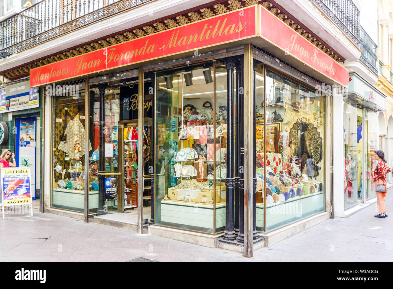 Seville, Spain - September 3rd 2015: Woman looking in shop window ...