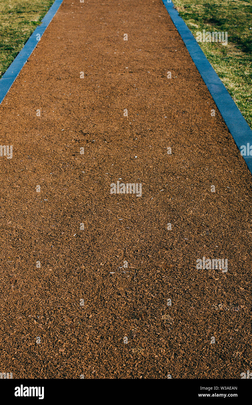 Rubber running path in a park in view Stock Photo - Alamy