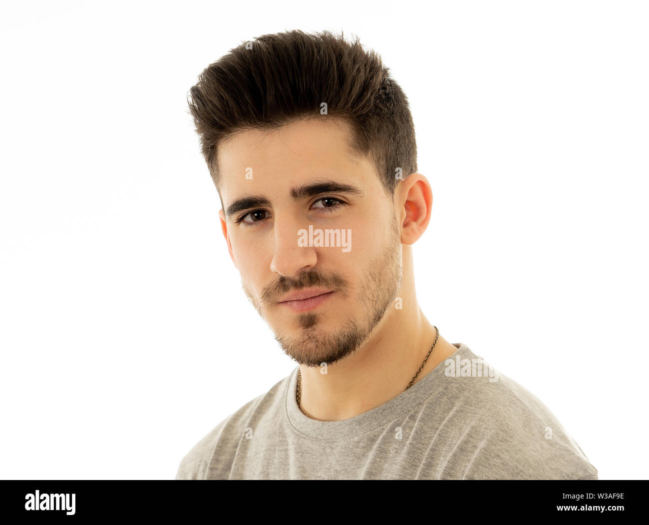 Close up portrait of attractive, confident young man looking neutral ...