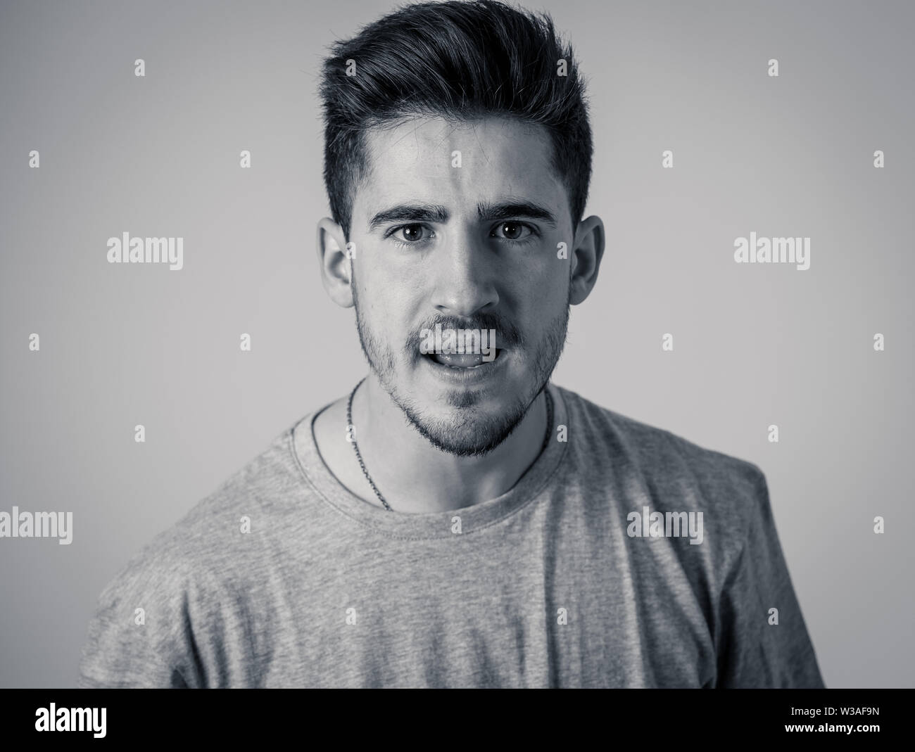 Close up portrait of young man with angry face feeling anger and ...