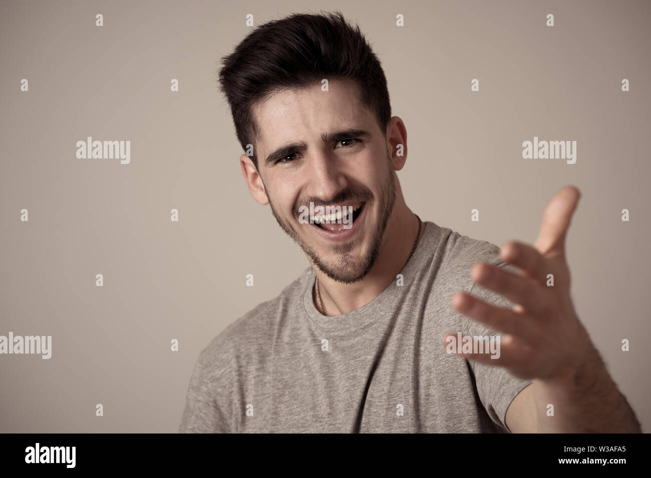 Portrait of young man celebrating achievement, a football goal, wining ...