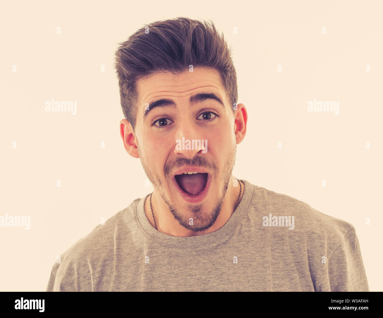 Portrait of young man celebrating achievement, a football goal, wining ...