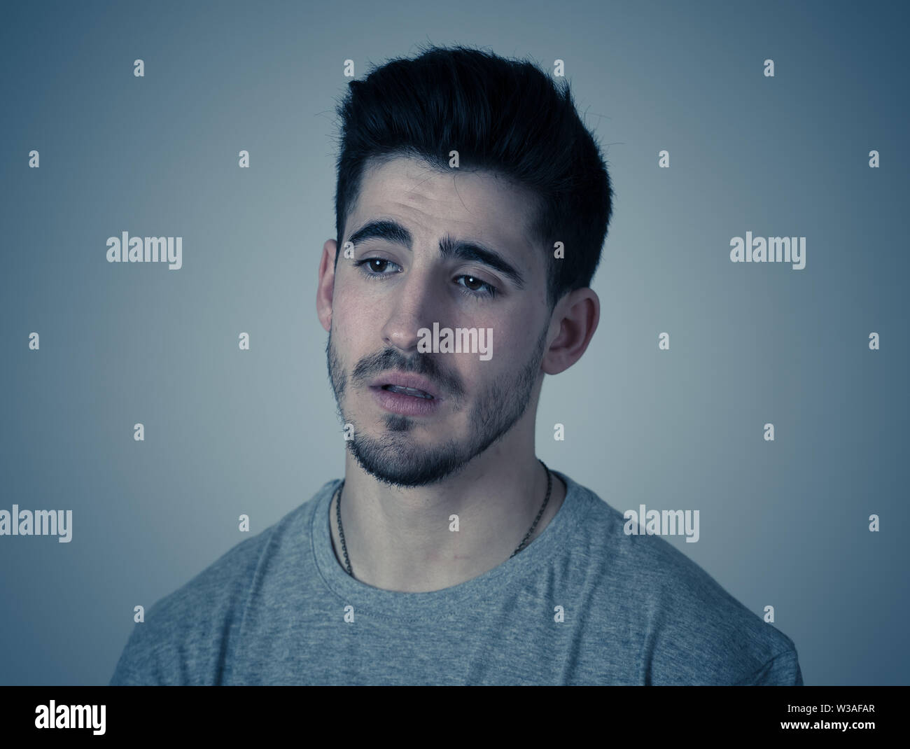 Close up portrait of handsome desperate young man suffering from ...