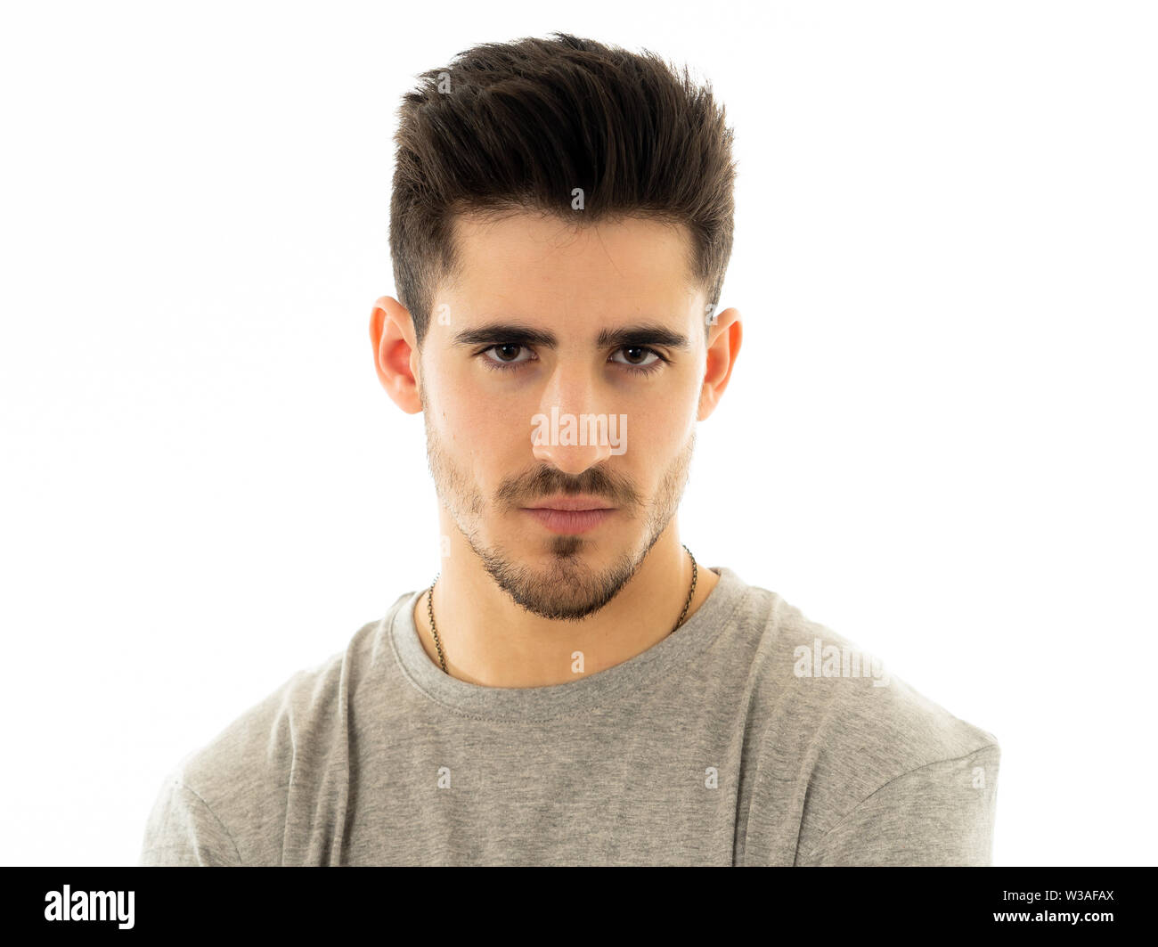 Close up portrait of attractive, confident young man looking neutral ...
