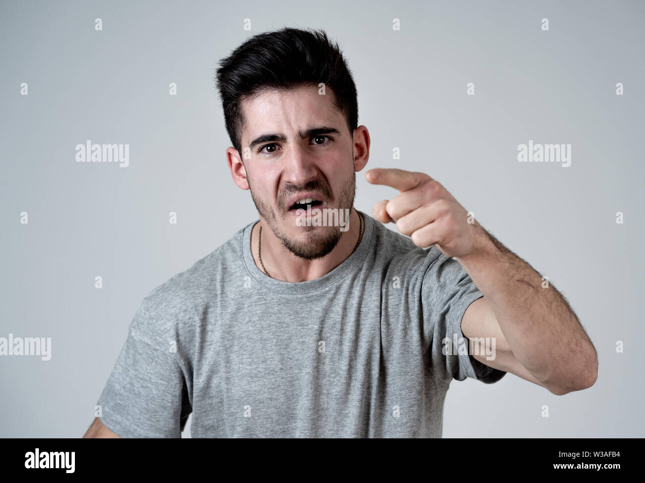 Close up portrait of young violent man with angry face looking furious ...