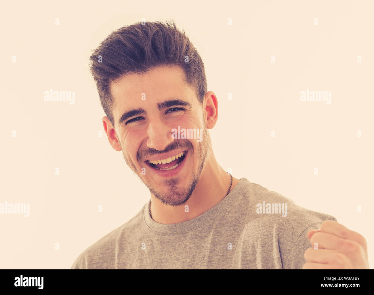 Portrait of young man celebrating achievement, a football goal, wining ...