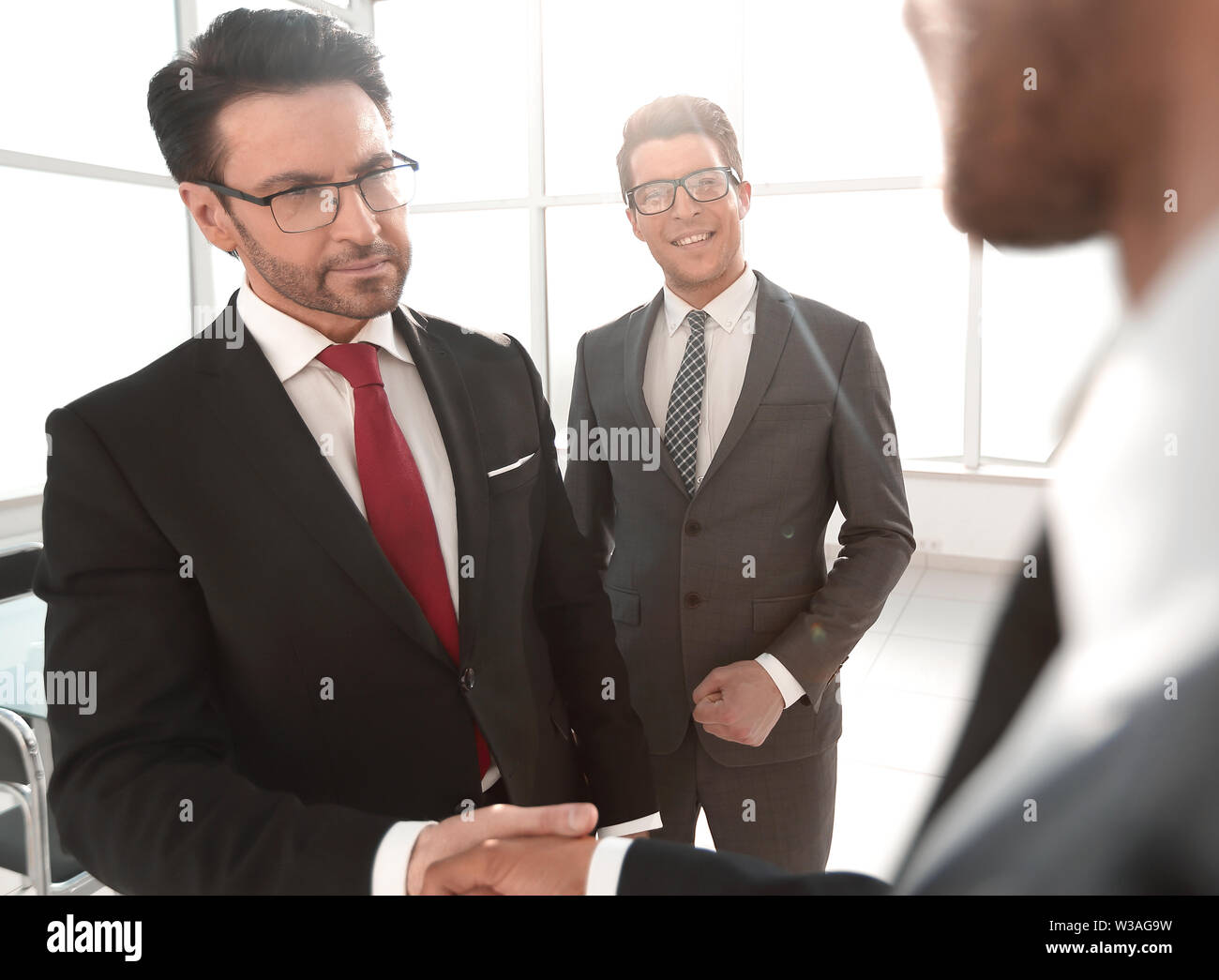 Manager shaking the hand of the customer Stock Photo - Alamy