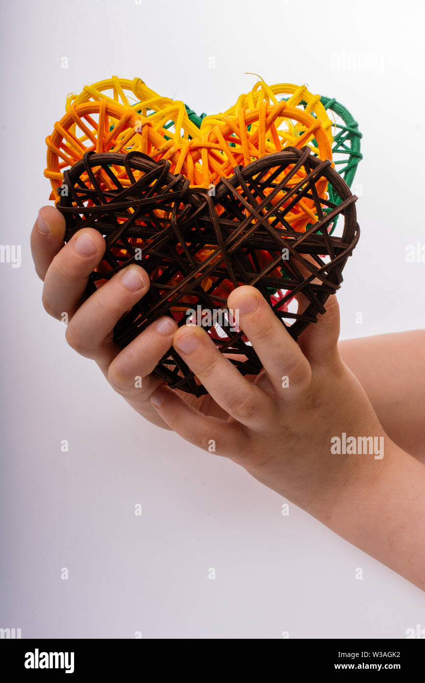 Handmade straw heart or valentines day object in hand Stock Photo - Alamy