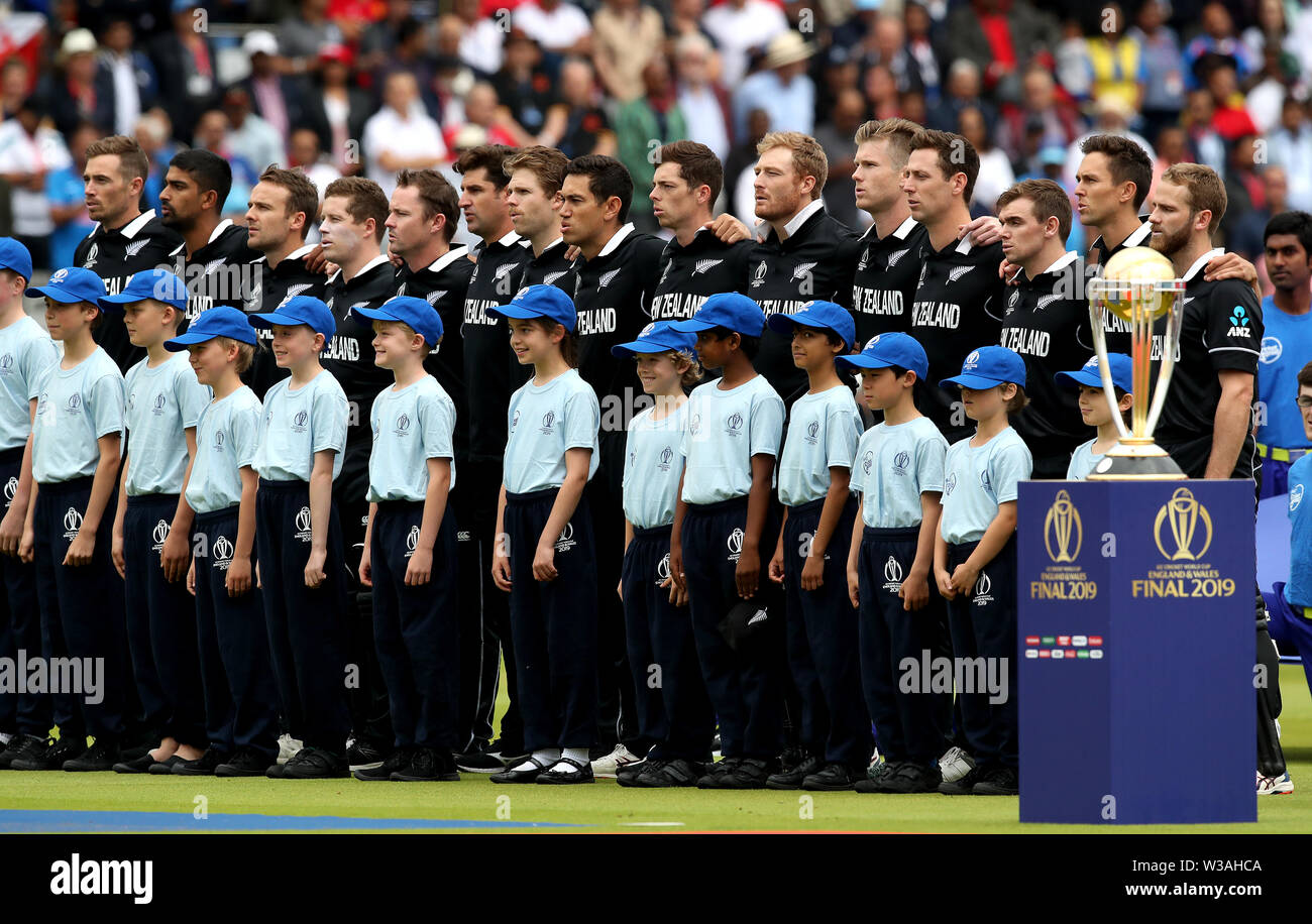 New Zealand captain Kane Williamson (right) stands with his players for ...