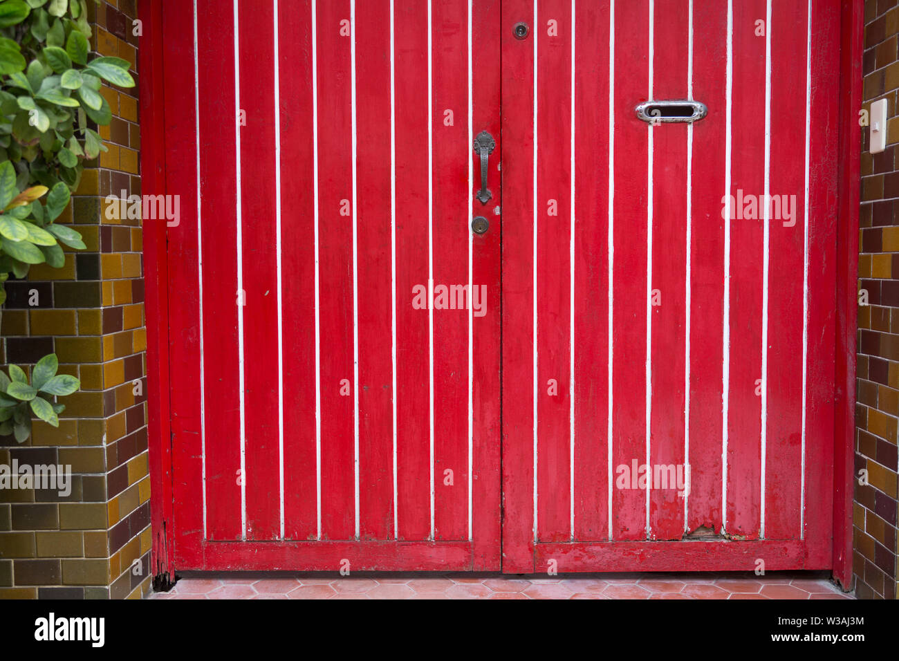 Red wooden panel double doors with mail slot Stock Photo - Alamy