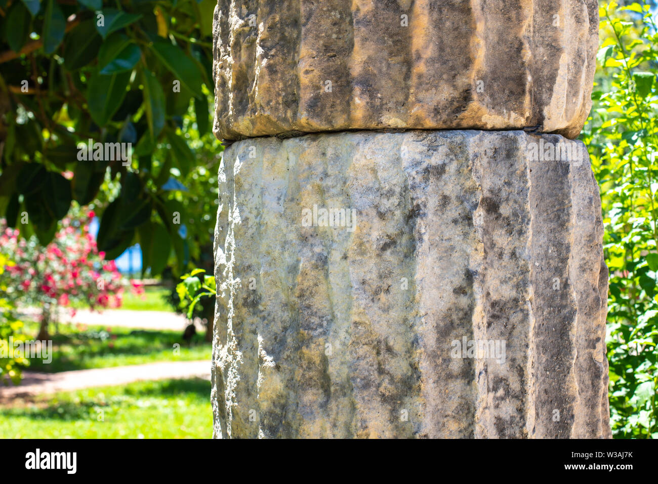 Classic Roman columns. A picturesque alley with antique decorations ...