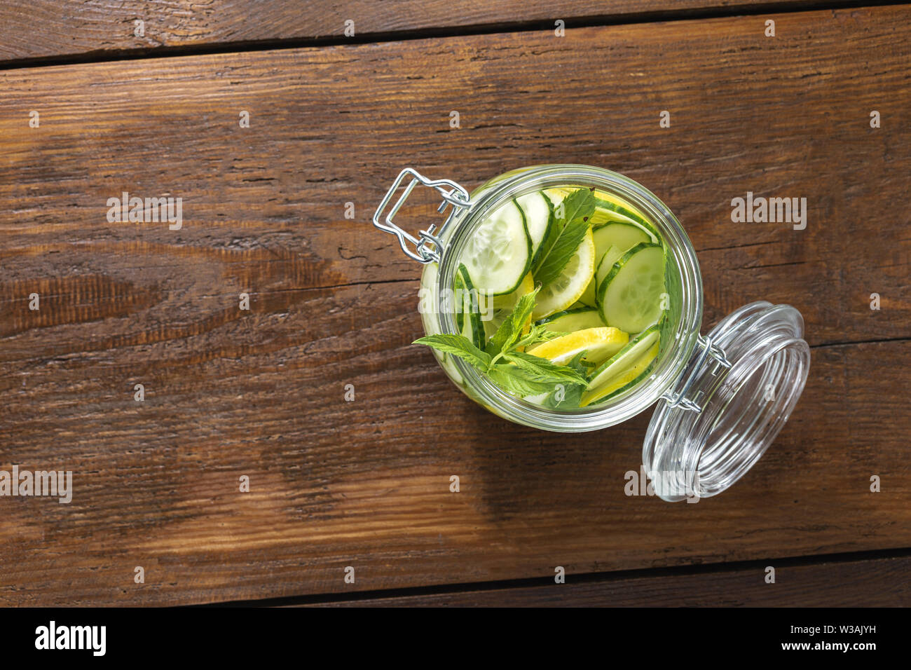 Detox drink cucumber water on wooden teble with copy space top view ...