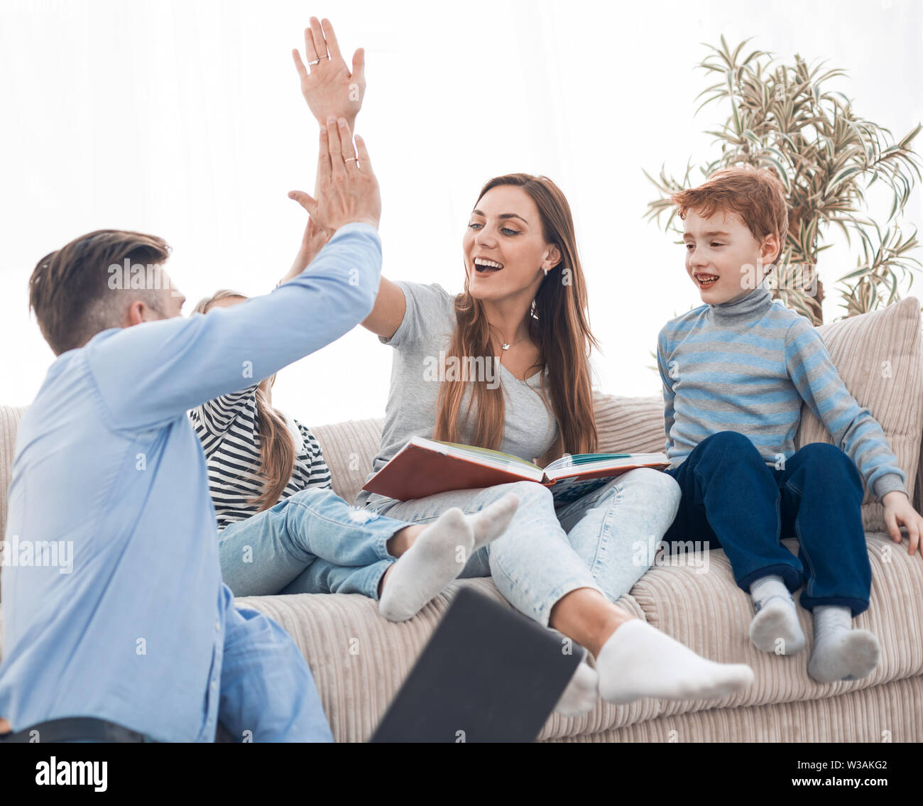 happy parents giving each other a high five Stock Photo - Alamy