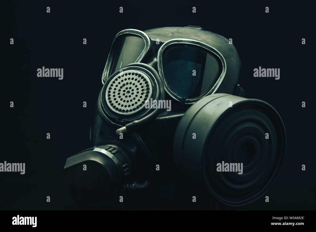 Gas mask on a black table and dark background Stock Photo - Alamy