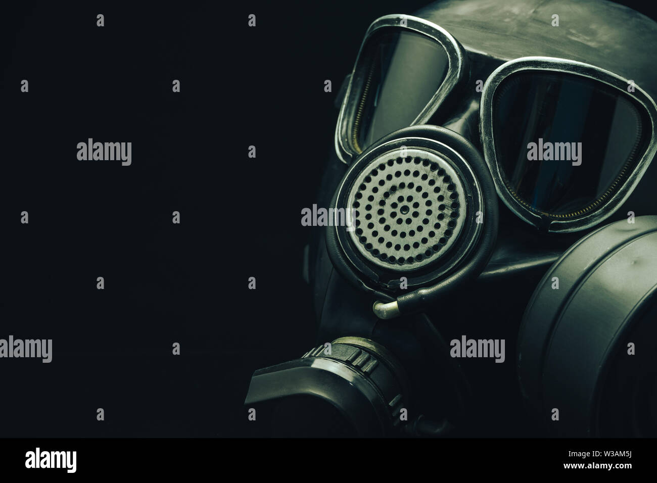 Gas mask on a black table and dark background Stock Photo - Alamy
