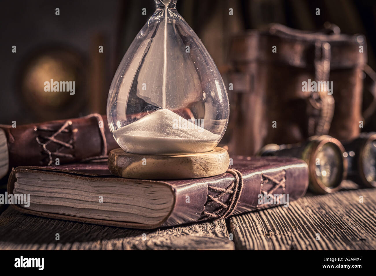 Aged journal and hourglass as a concept of journey memories Stock Photo ...
