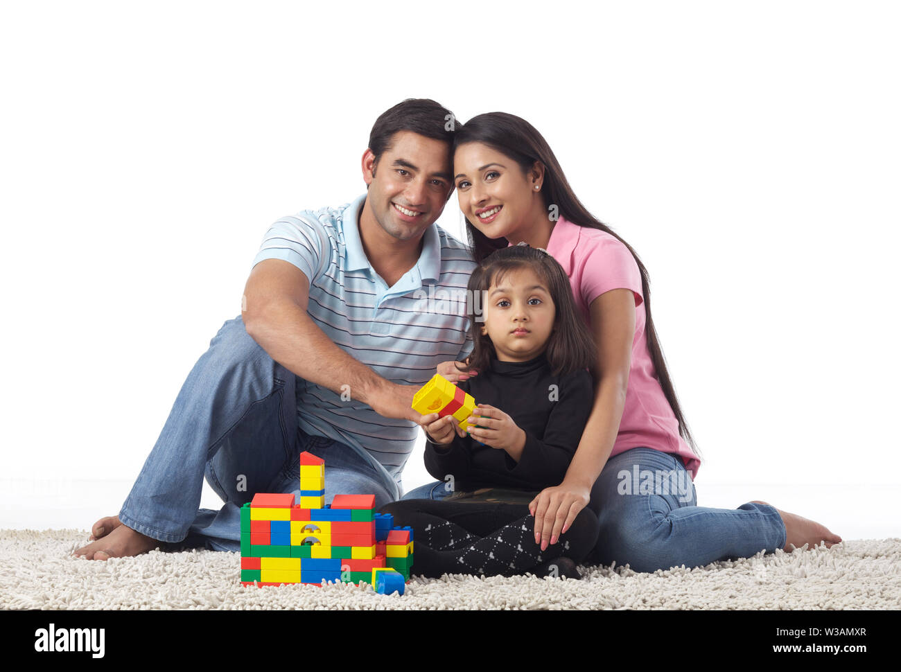 Family sitting on rug Stock Photo - Alamy