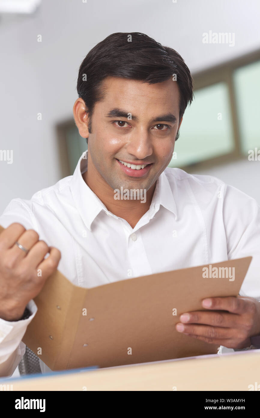 Indian businessman doing paperwork in an office Stock Photo - Alamy
