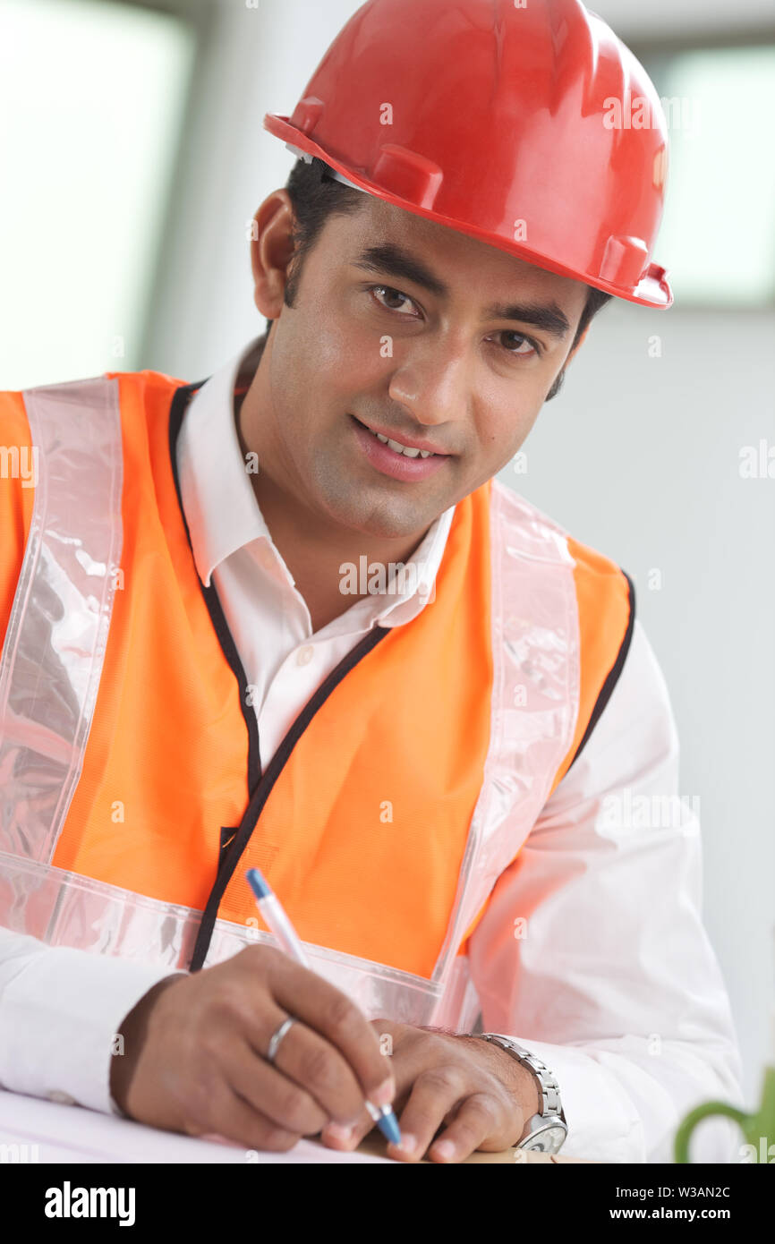 Architect doing paperwork in an office Stock Photo - Alamy