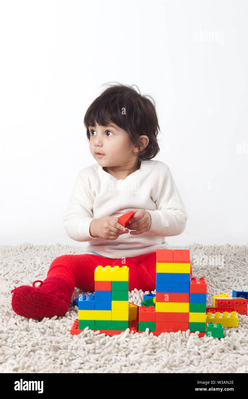 Girl playing with blocks Stock Photo - Alamy