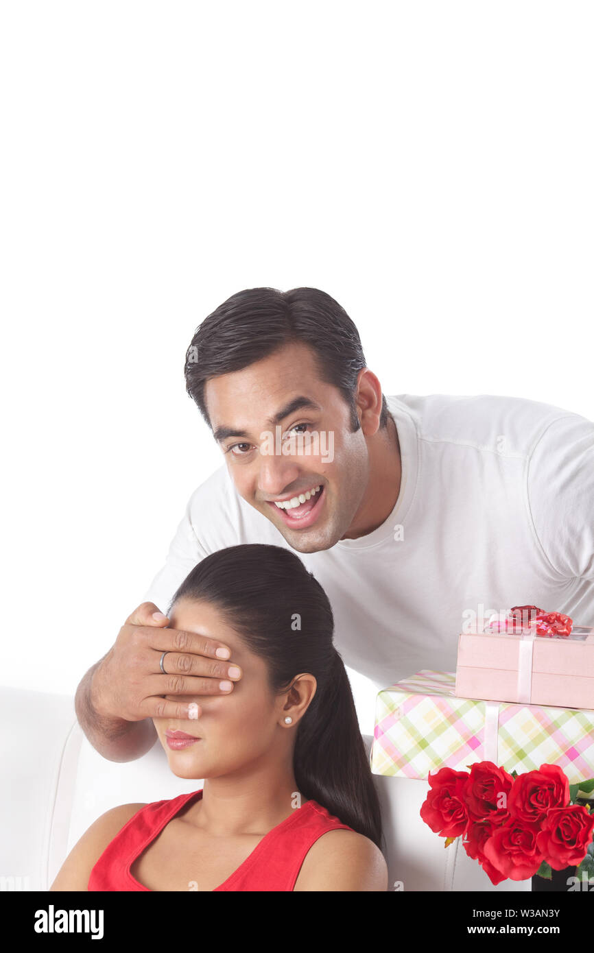 Man giving surprise gift to a woman Stock Photo - Alamy