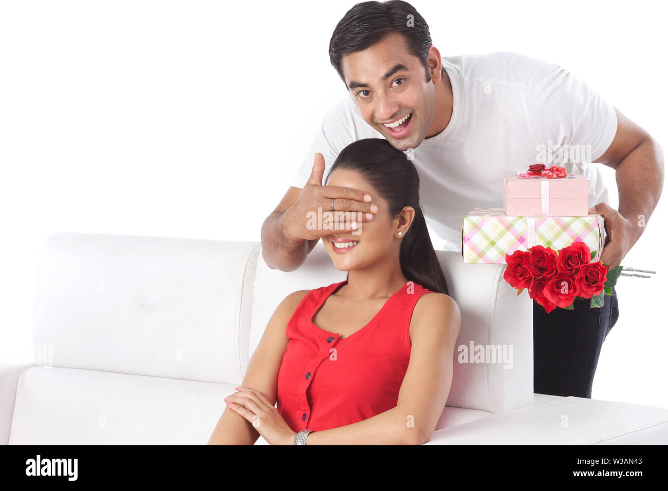 Man giving surprise gift to a woman Stock Photo - Alamy