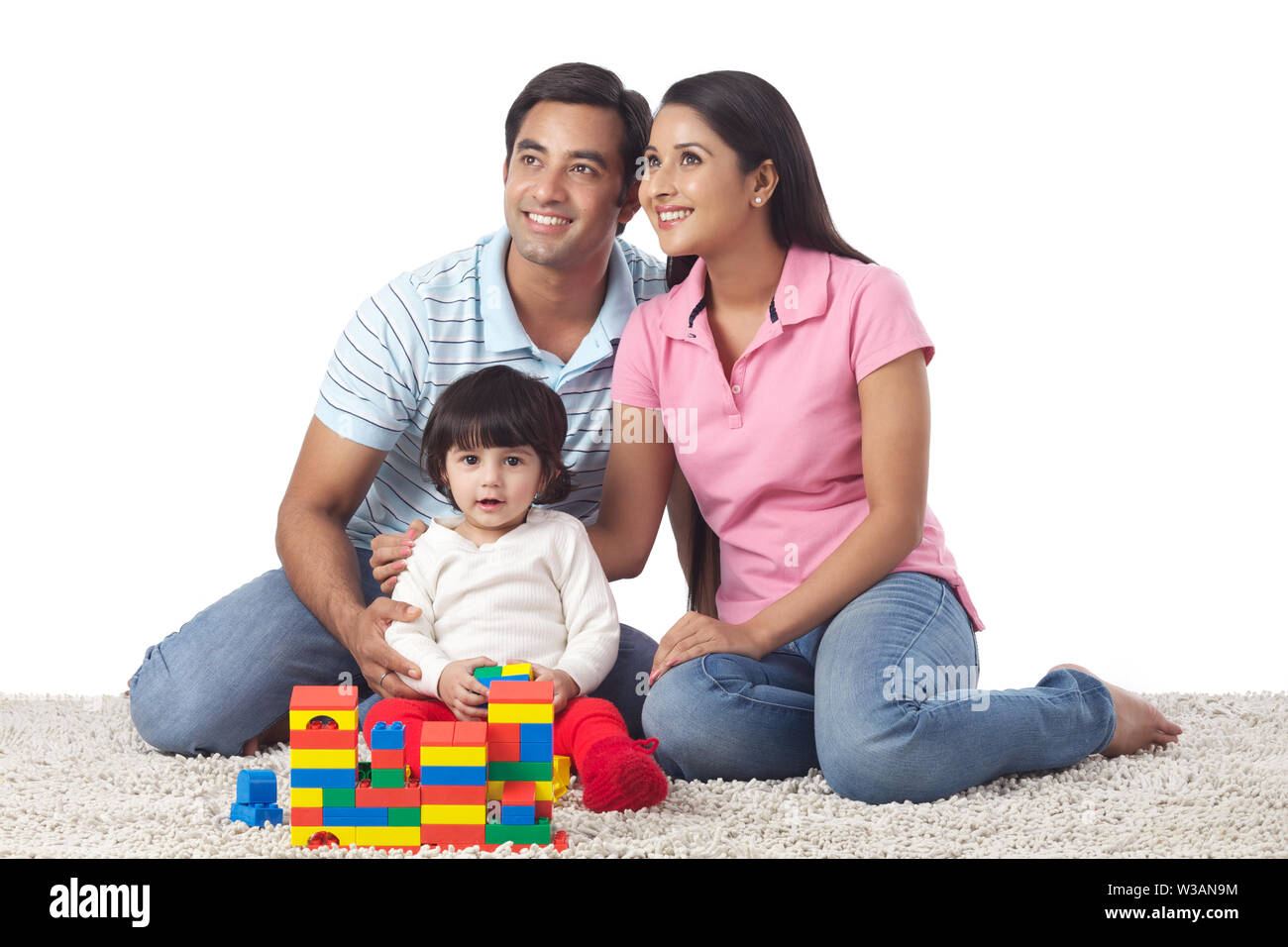 Family sitting on rug Stock Photo - Alamy