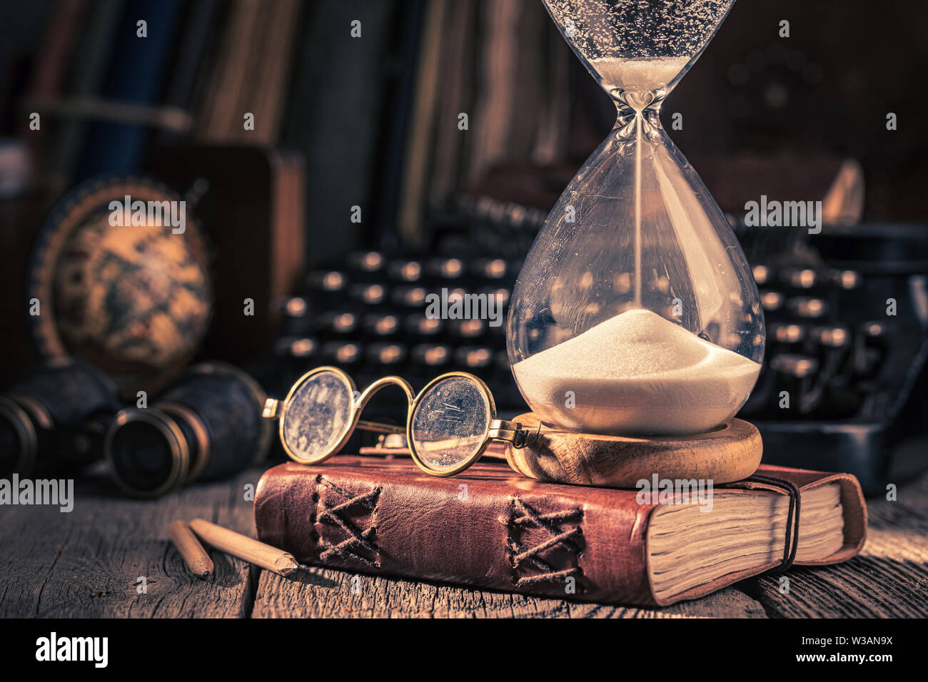Aged journal and hourglass with binocular, compass and books Stock ...
