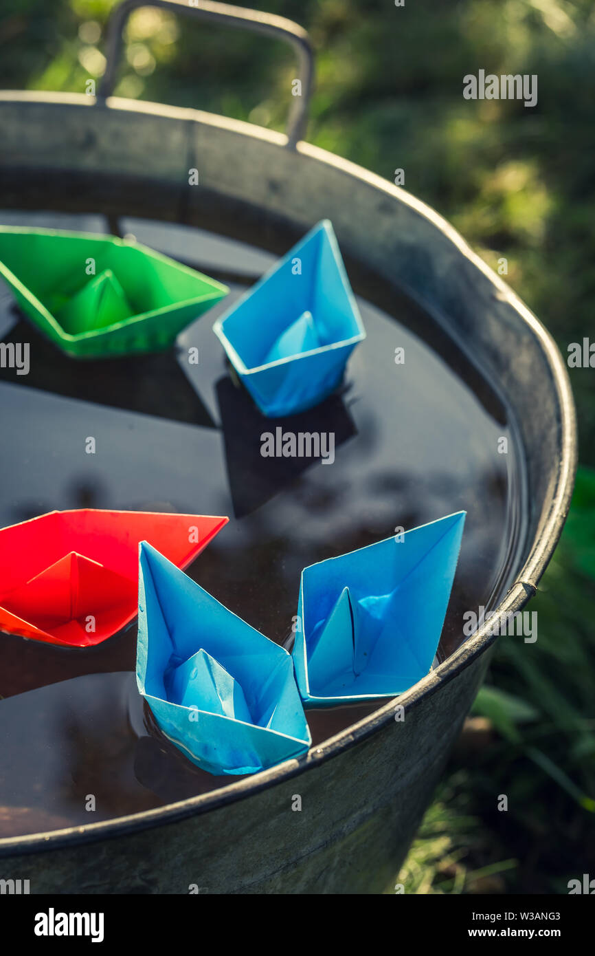Handmade color paper boats on water as travel concept Stock Photo - Alamy