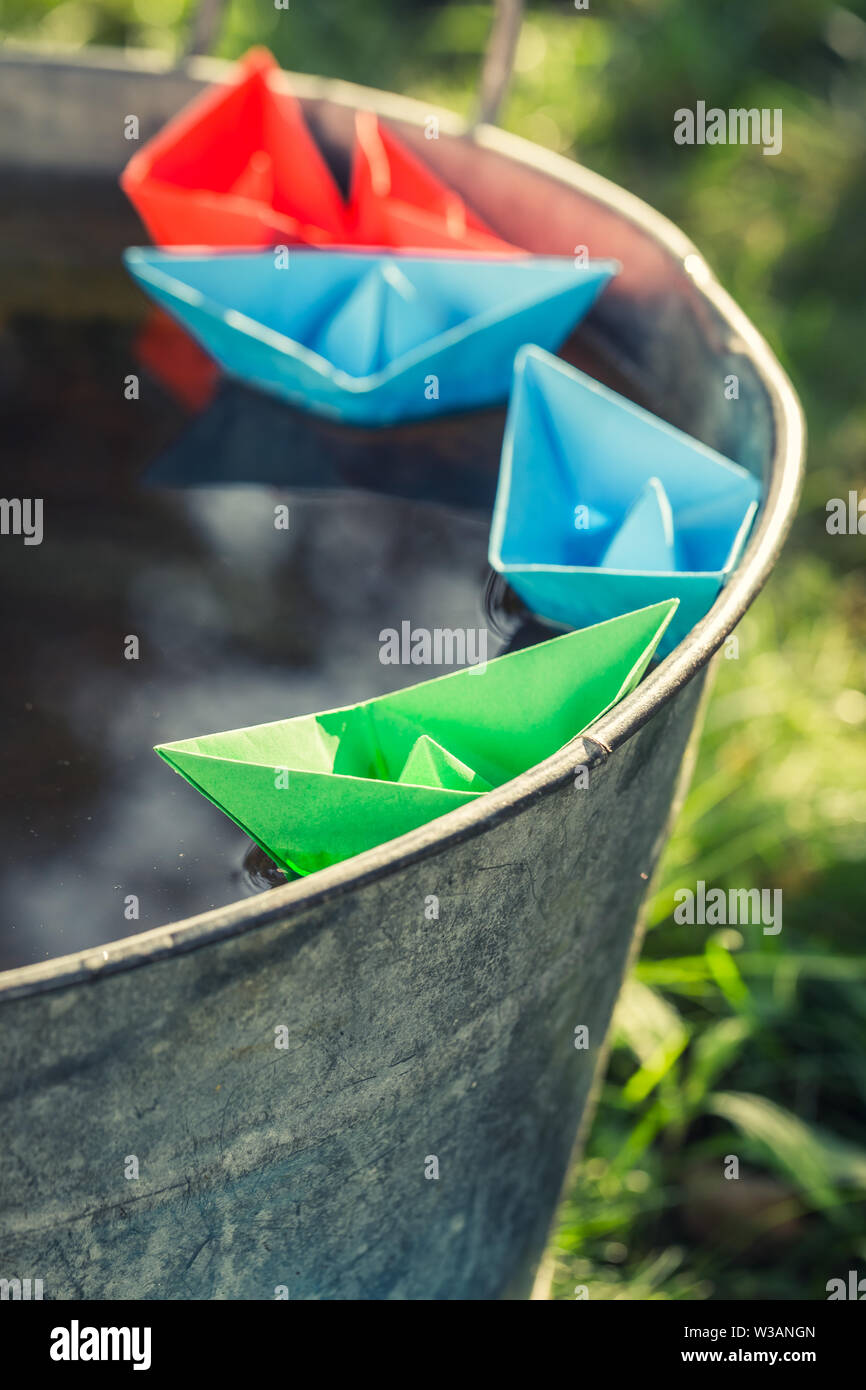 Handmade color paper boats quietly floating on water in summr Stock ...